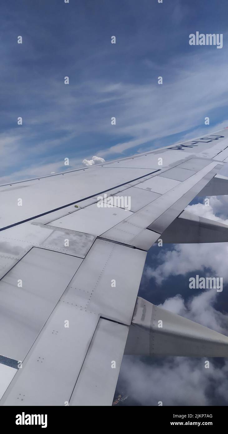 a vertical shot of plane wing in sky Stock Photo - Alamy
