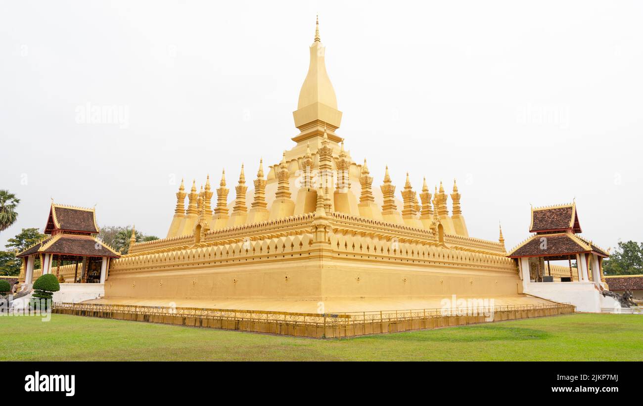 A scenic view of Pha That Luang Buddhist stupa in the center of the ...