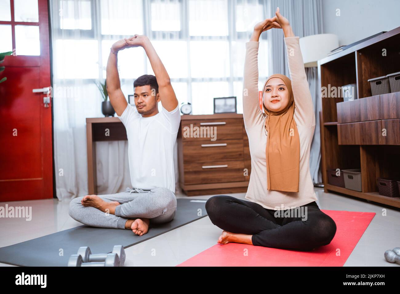 partner workout and stretching together at living room Stock Photo - Alamy