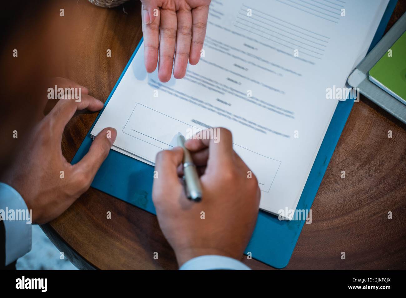 businessman signing an agreement letter during meeting Stock Photo - Alamy
