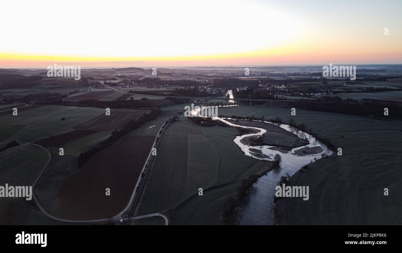A green field with river in the middle during a scenic sunset Stock ...
