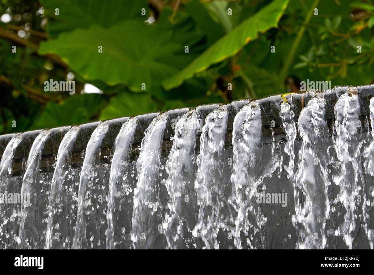 Landscape of man-made flowing water fountain in the park Stock Photo ...