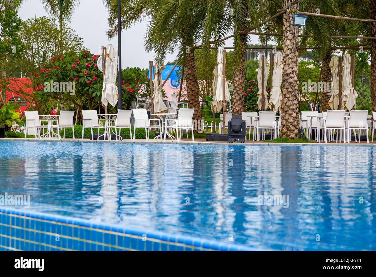 Infinity pool and lounge chairs in a luxury hotel Stock Photo - Alamy