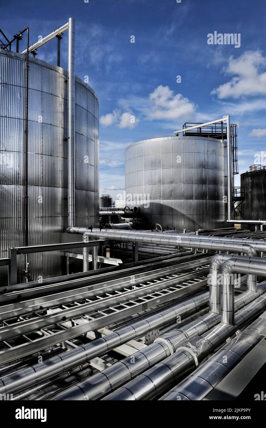A closeup of Pipes and tanks for processing crude oil Stock Photo - Alamy