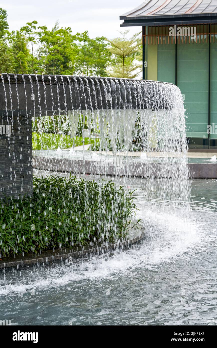Landscape of man-made flowing water fountain in the park Stock Photo ...