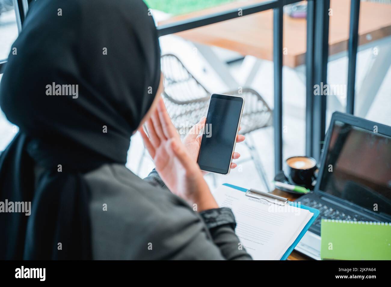 happy excited muslim woman suprised while looking at her phone Stock ...