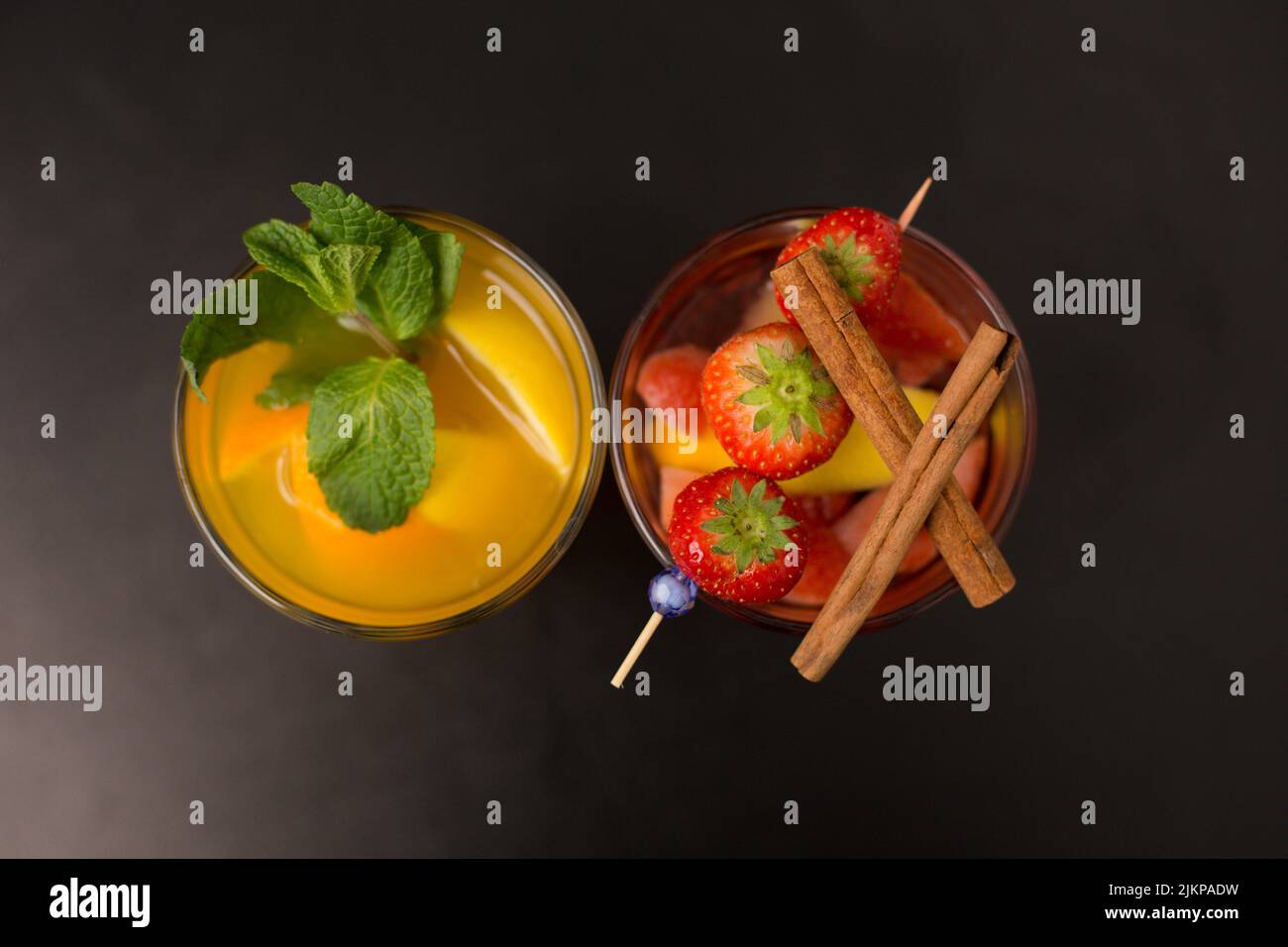 A top view of refreshing drinks with strawberry, lime and cinnamon ...