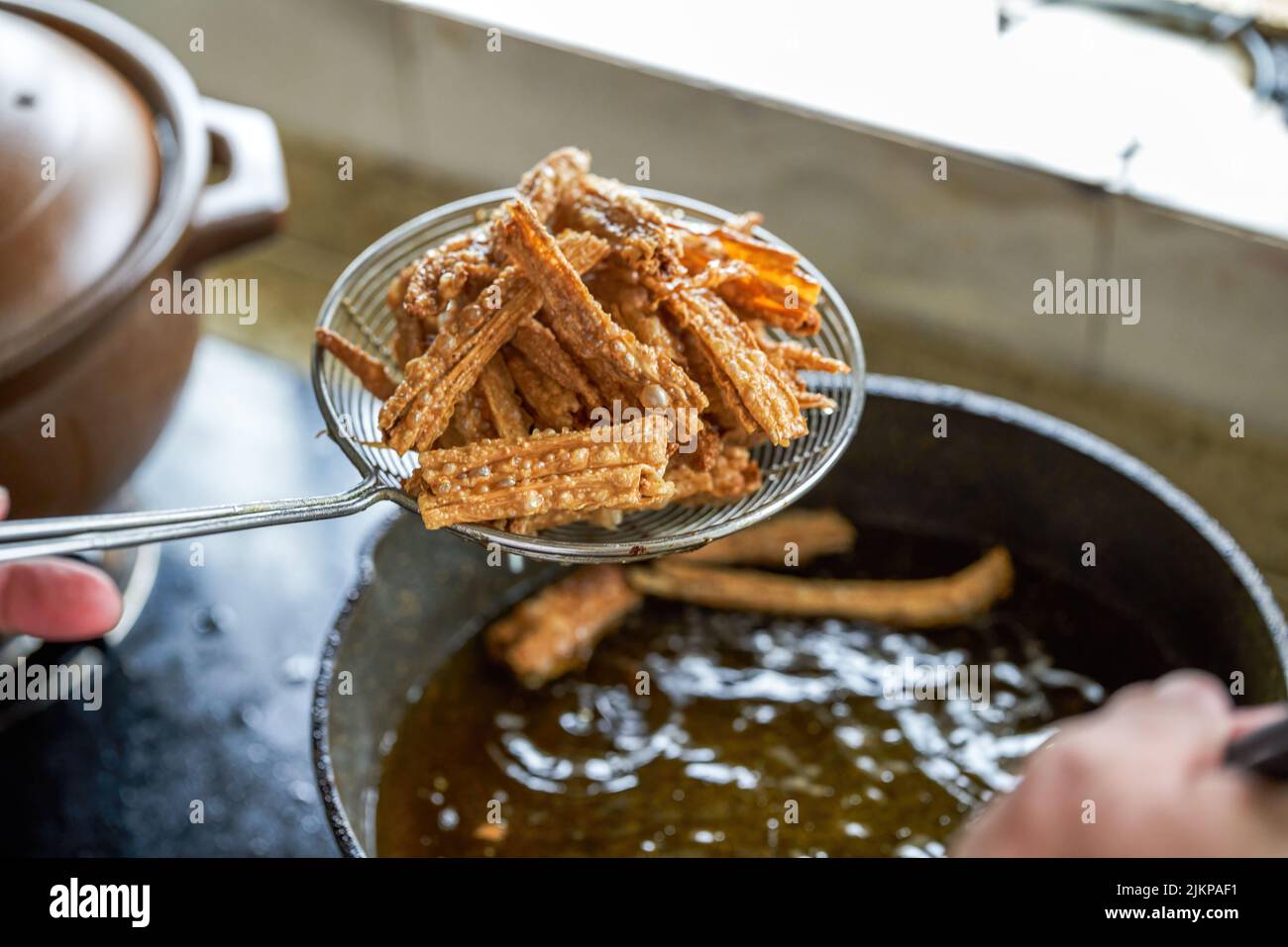 A chef in the kitchen is making fried yuba Stock Photo - Alamy