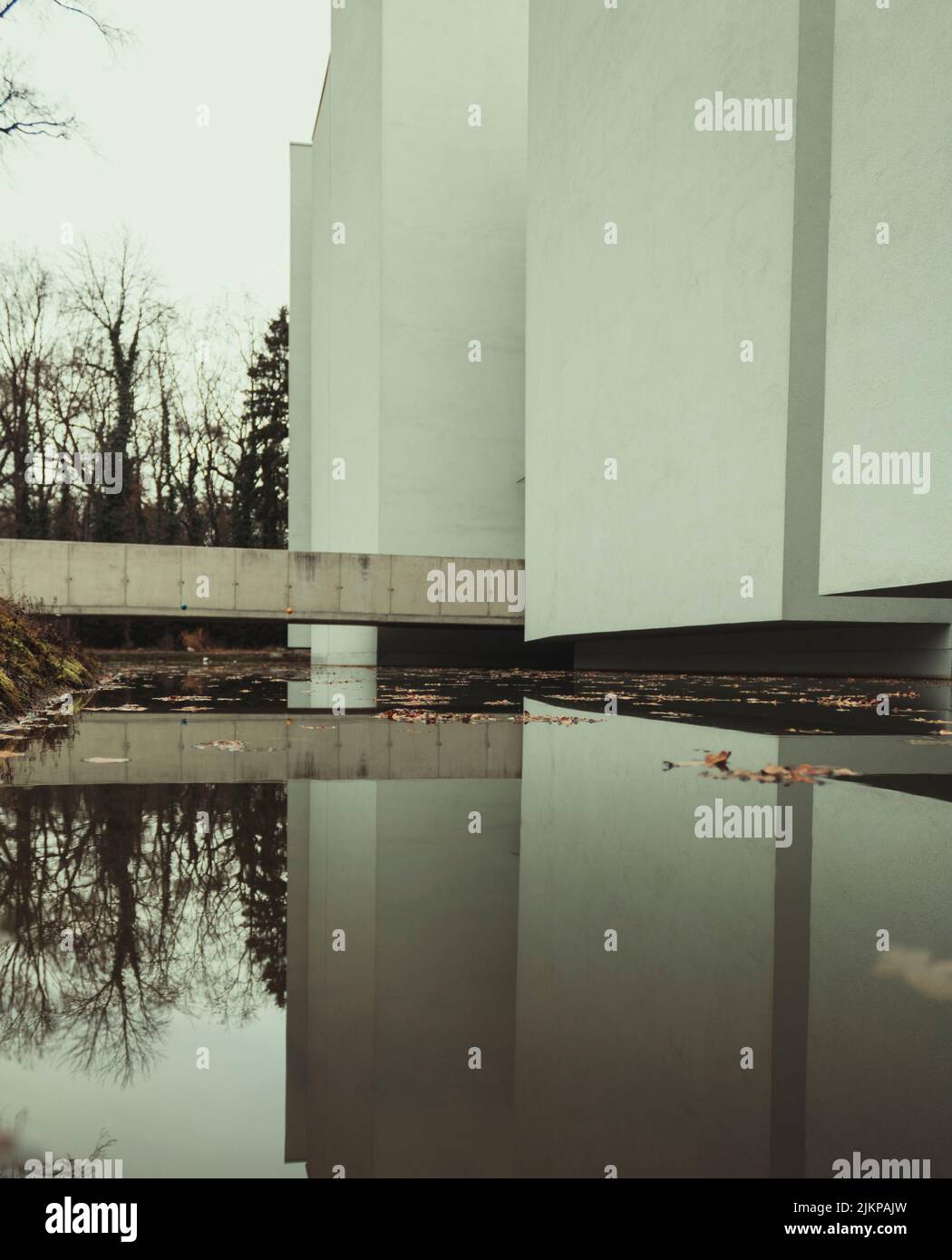 A vertical shot of white walls of a building on a cold autumn day with ...