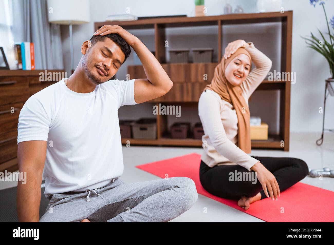 partner workout and stretching together at living room Stock Photo - Alamy