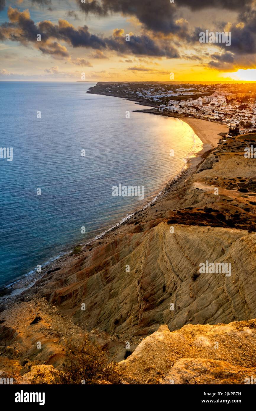 The mesmerizing sunset sky over the sea and coastal town Lagos, Praia ...