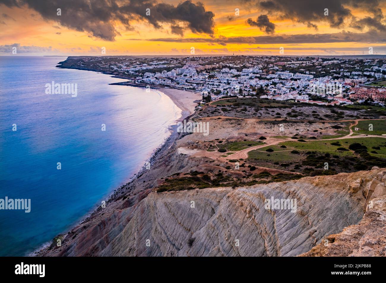 A mesmerizing sunset view of the sea and Lagos, Praia Da Luz in summer ...