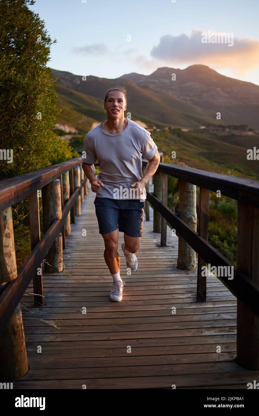 Time to get those endorphins going. a young man running alone outside ...