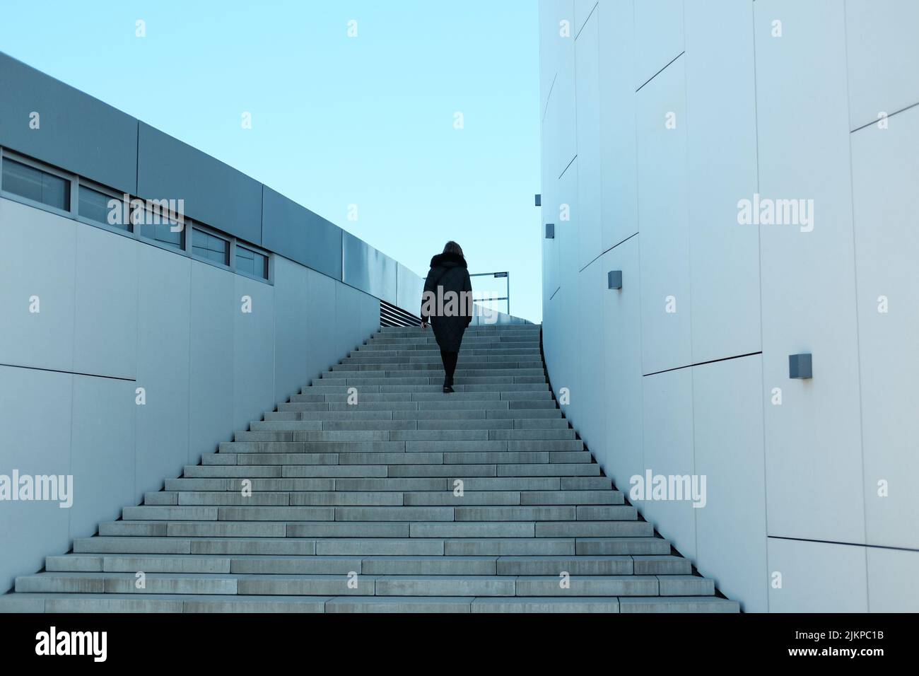 Woman climbing stairs hi-res stock photography and images - Alamy