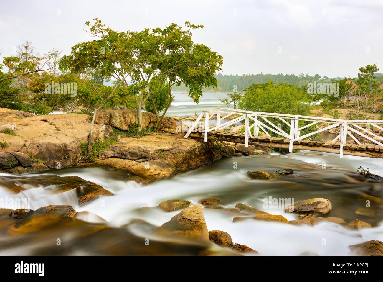 A perspective shot of a bridge over a river in the rocky landscape ...