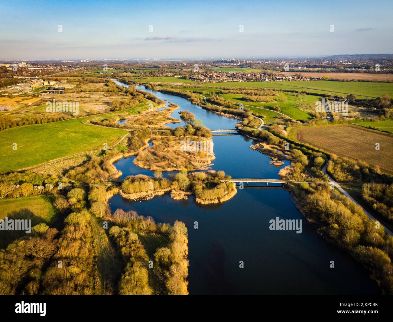 An aerial view of a bridge over a lake connected to an island full of ...
