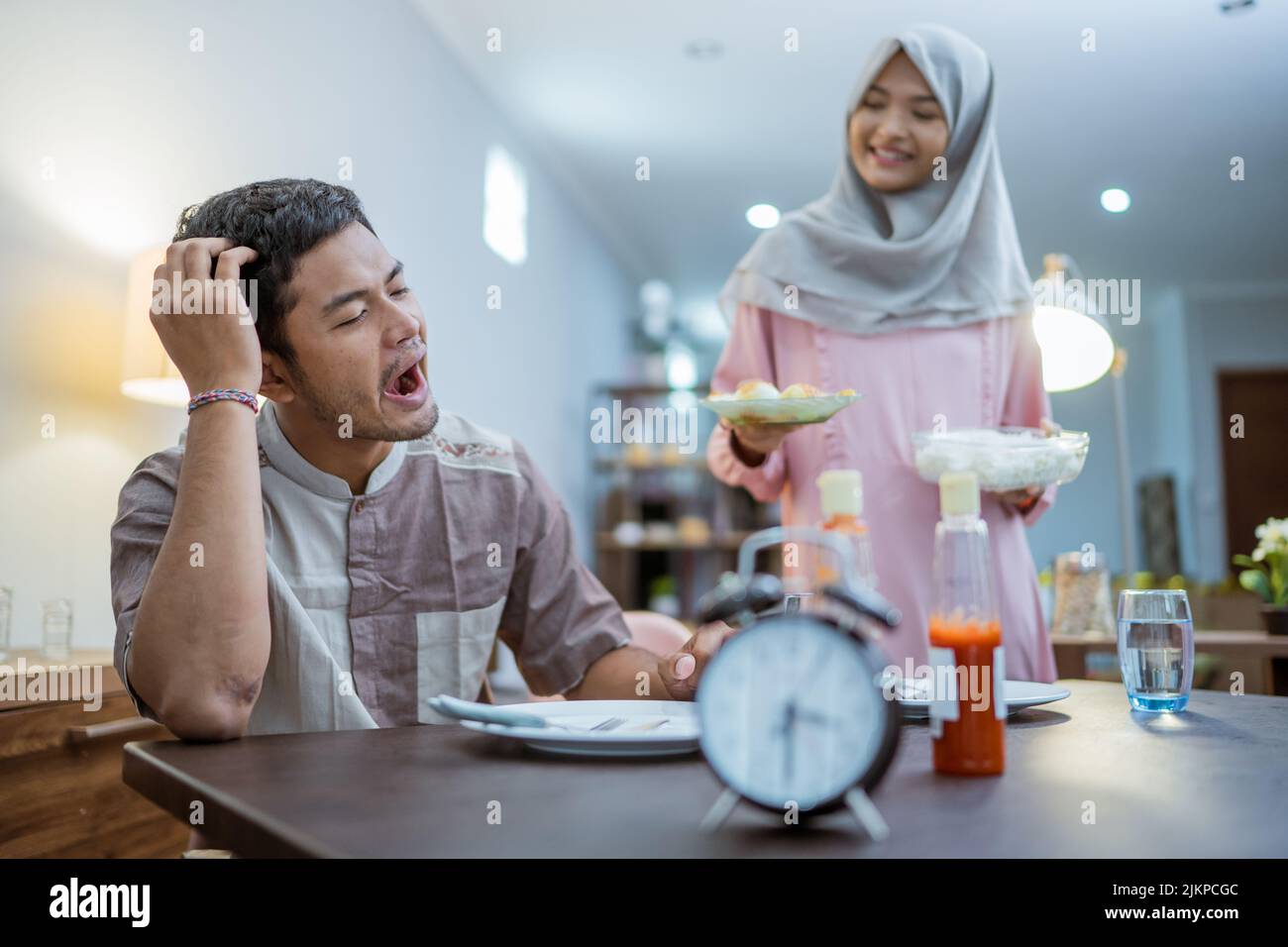 Sleepy asian man having breakfast hi-res stock photography and images ...