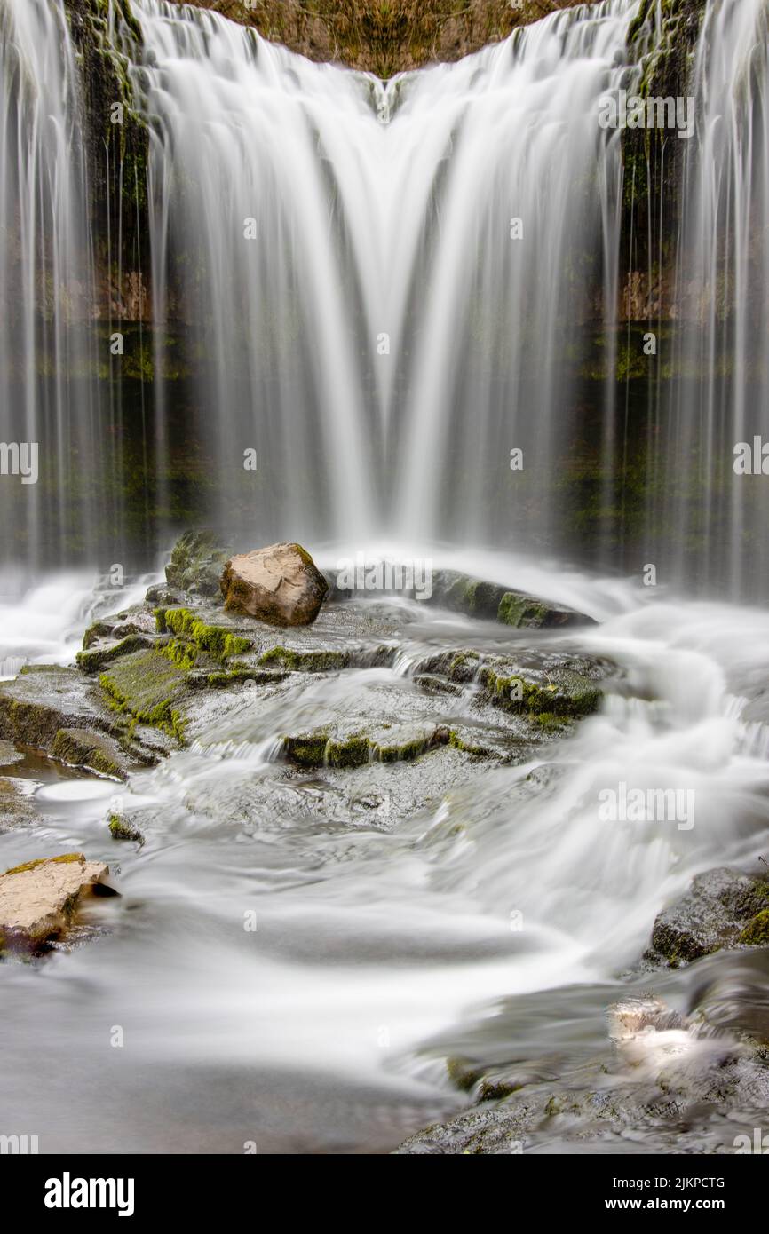 A vertical shot of a waterfall with a mirror effect Stock Photo - Alamy