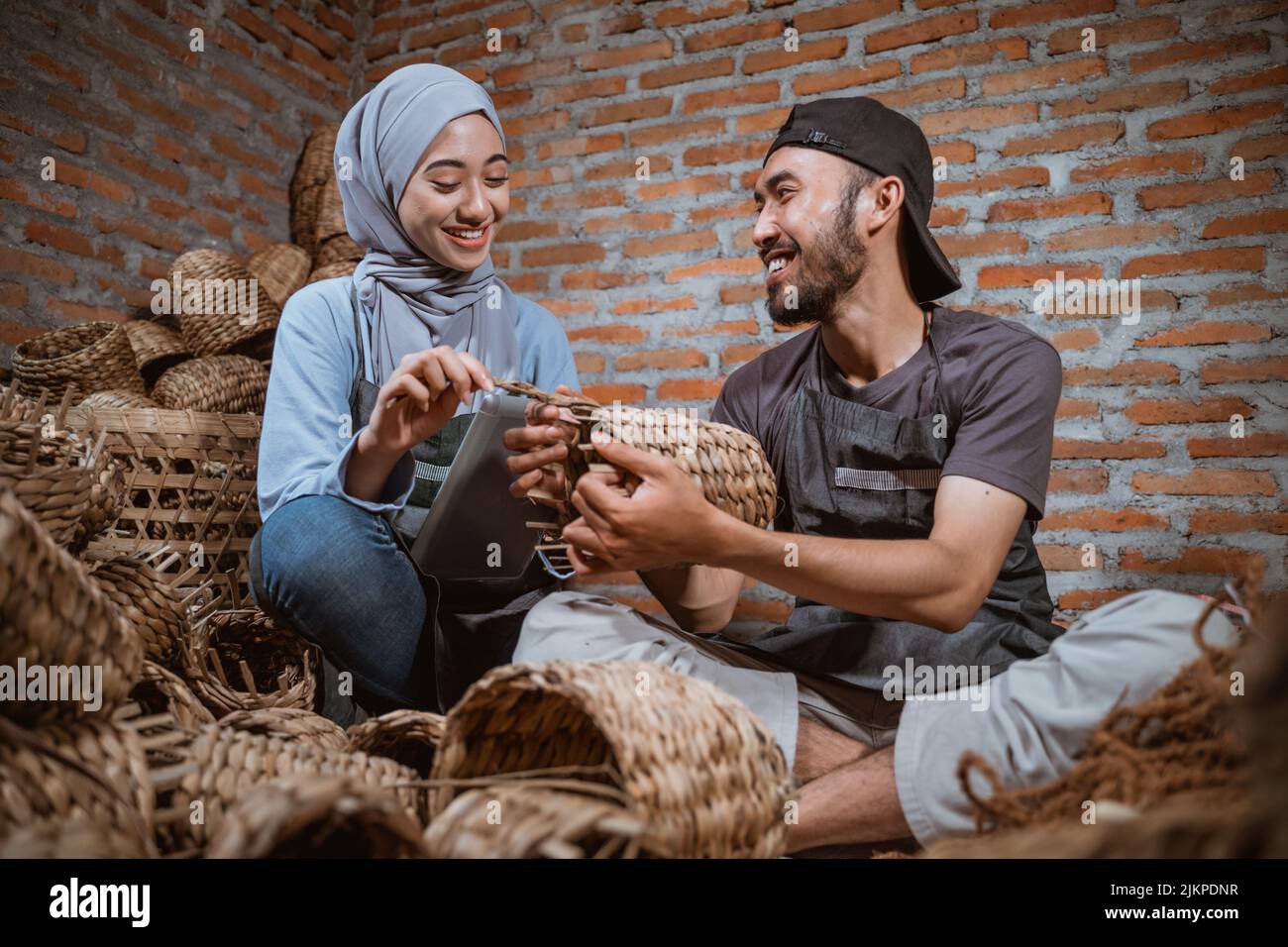 craftsman weaving water hyacinth handicrafts with woman in hijab Stock ...
