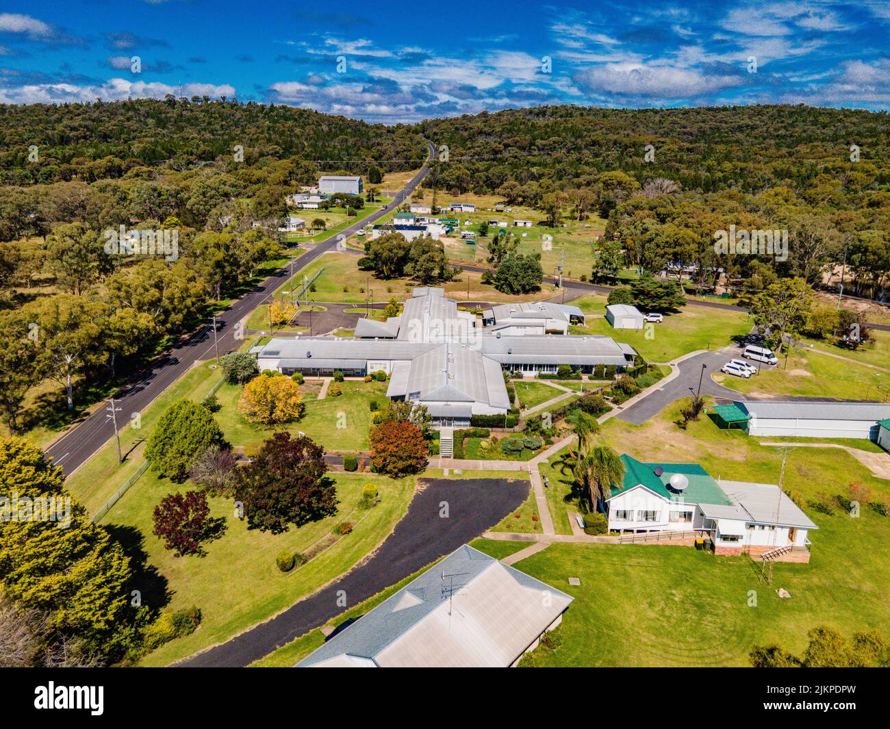 An aerial view of the lush green mountains of Emmaville with houses ...