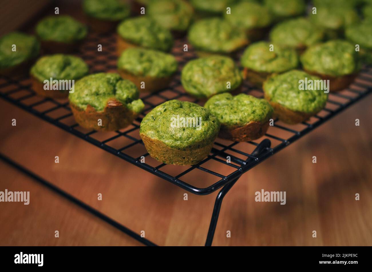 ready-made small green muffins with spinach on a baking sheet.healthy ...