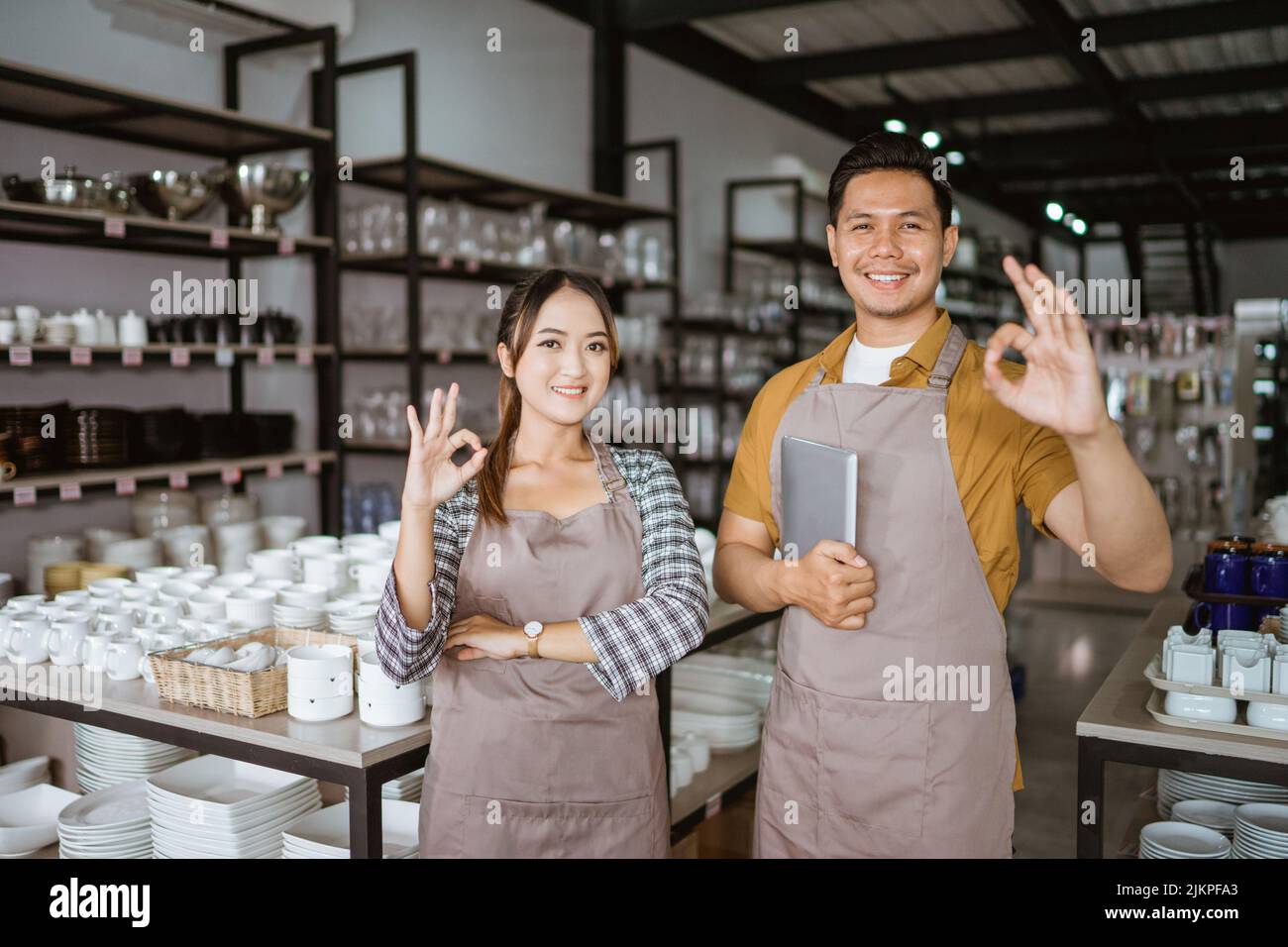 Two shop owners holding digital tablet with okay hand gesture Stock ...