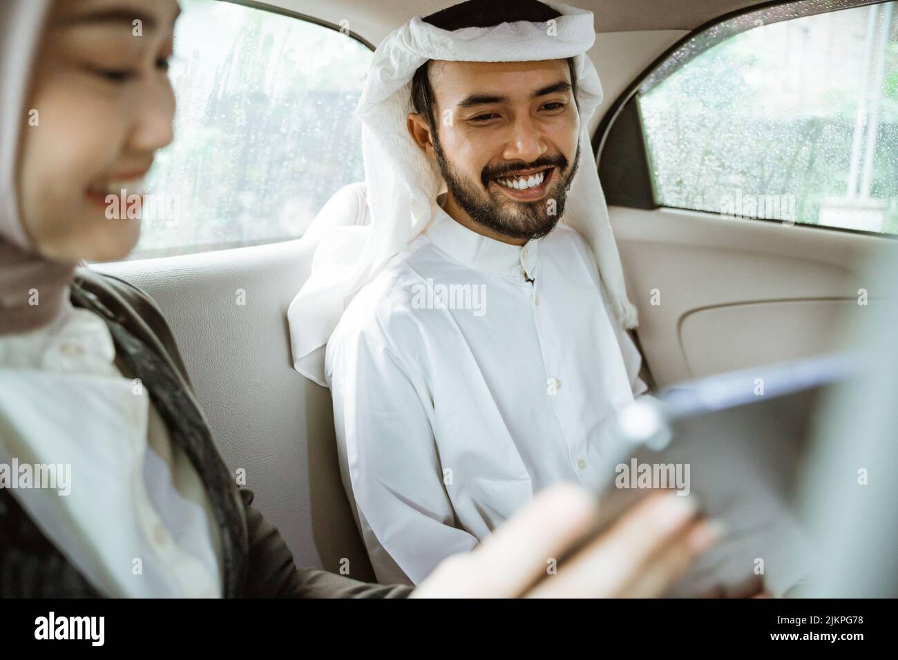 partner discussing using tablet pc presenting project while sitting on ...