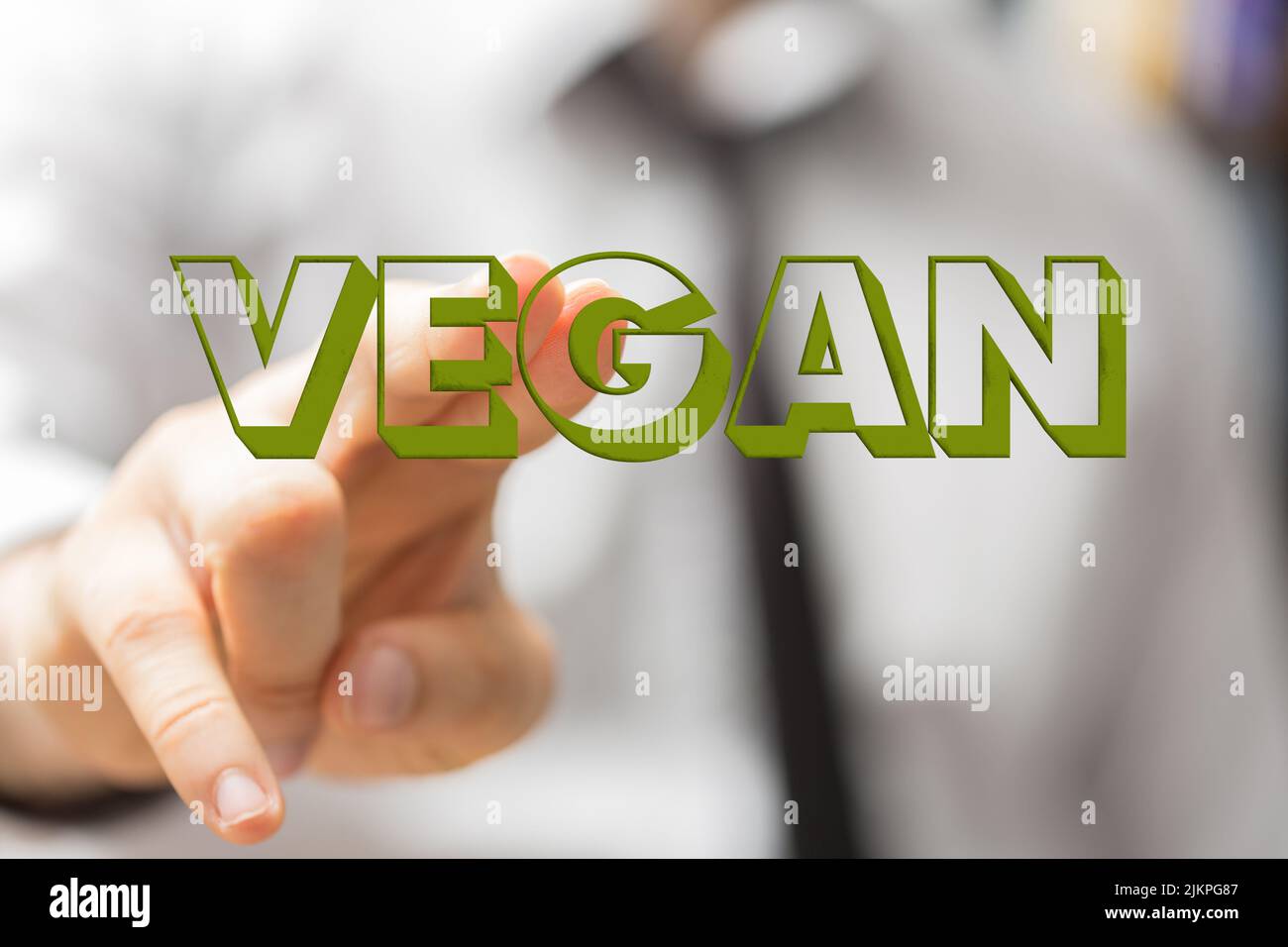 A person's hand showing an illustrated VEGAN text in green. Organic ...