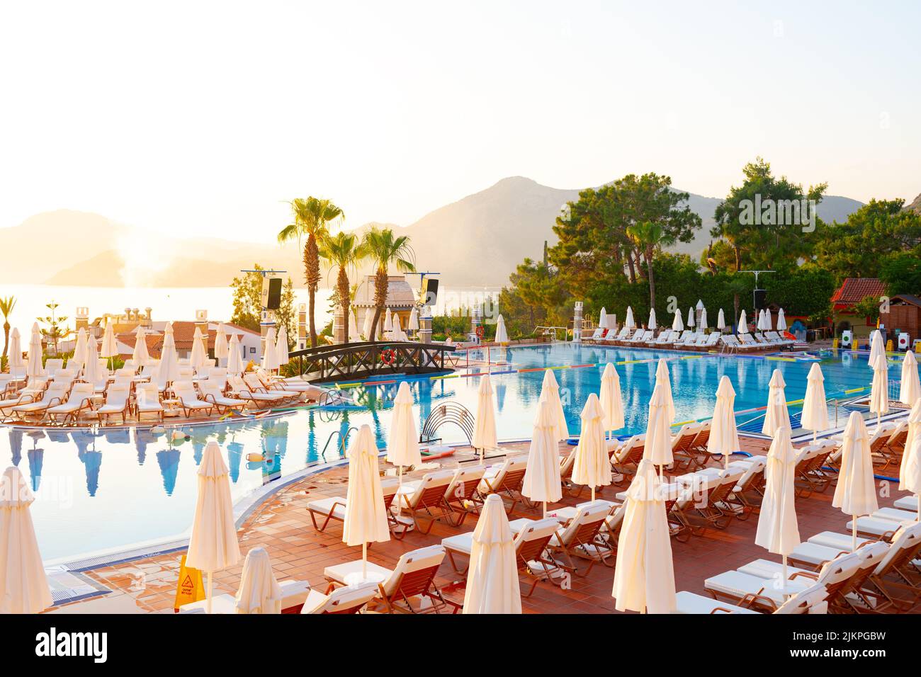 Pool with lounge chairs in resort hotel with mountain view Stock Photo ...