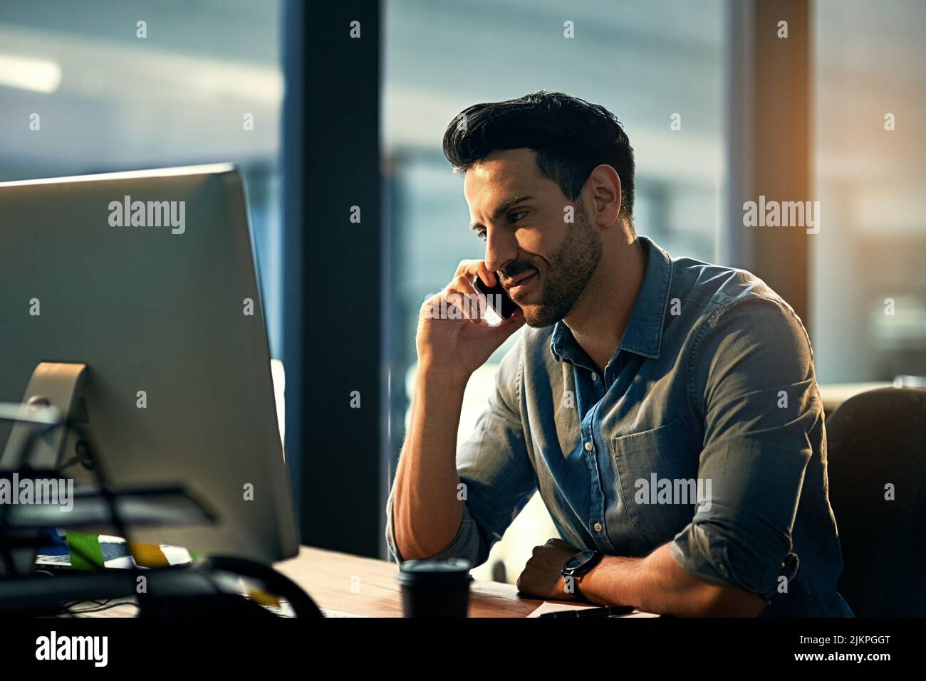 Making those late night connections. Shot of a young businessman ...