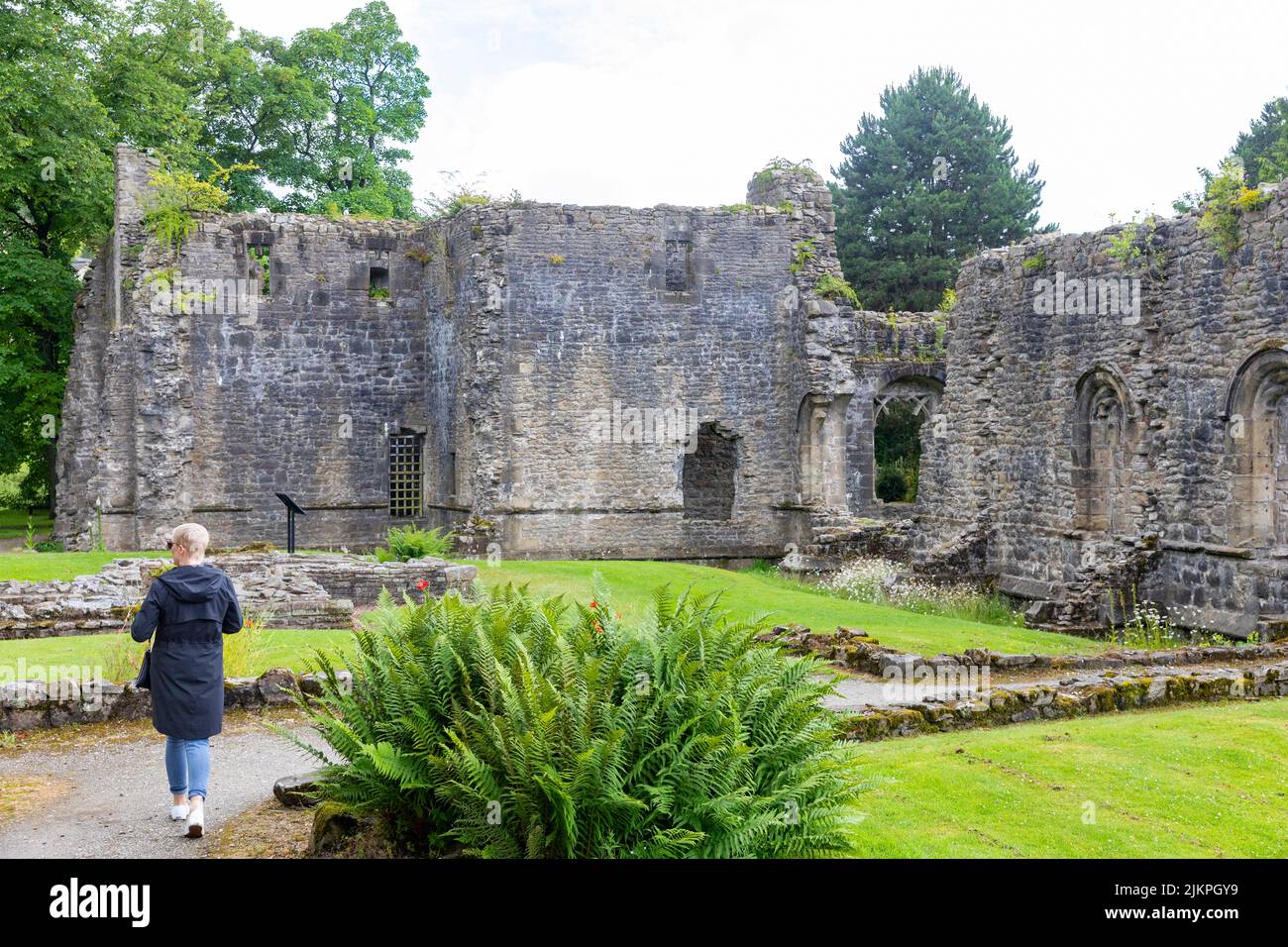 Whalley abbey ruins and grounds in Lancashire, woman visitor model ...