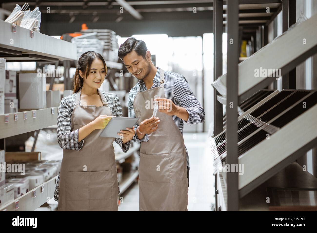 Boy and girl wearing apron using digital tablet to check Stock Photo ...