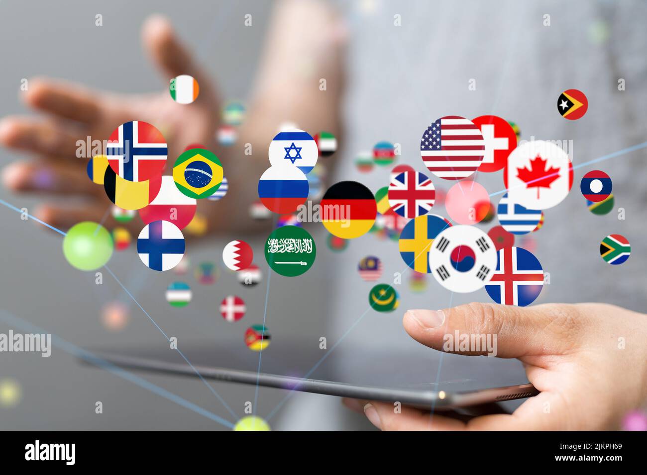 A 3D rendering of country flags over hand holding computer tablet ...