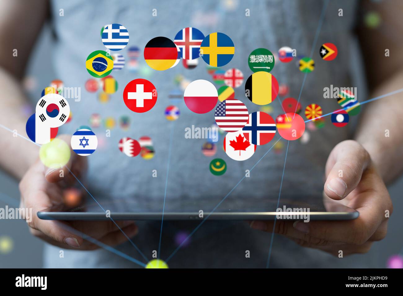 A 3D rendering of world flags over hands holding digital tablet-Global ...