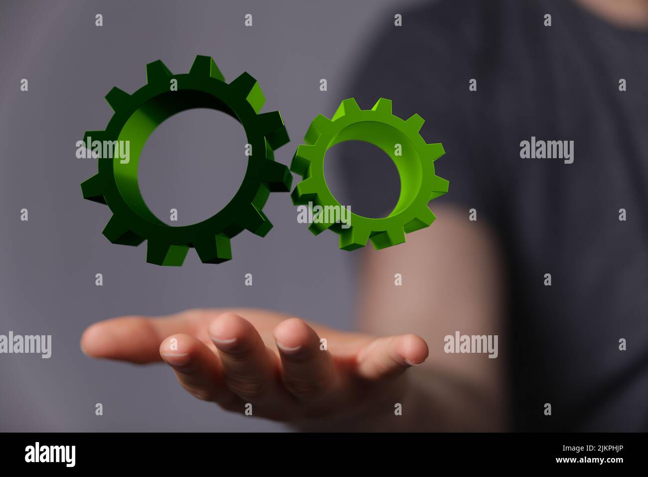 A 3d rendering of green gears floating on a hand-Eco green environment ...