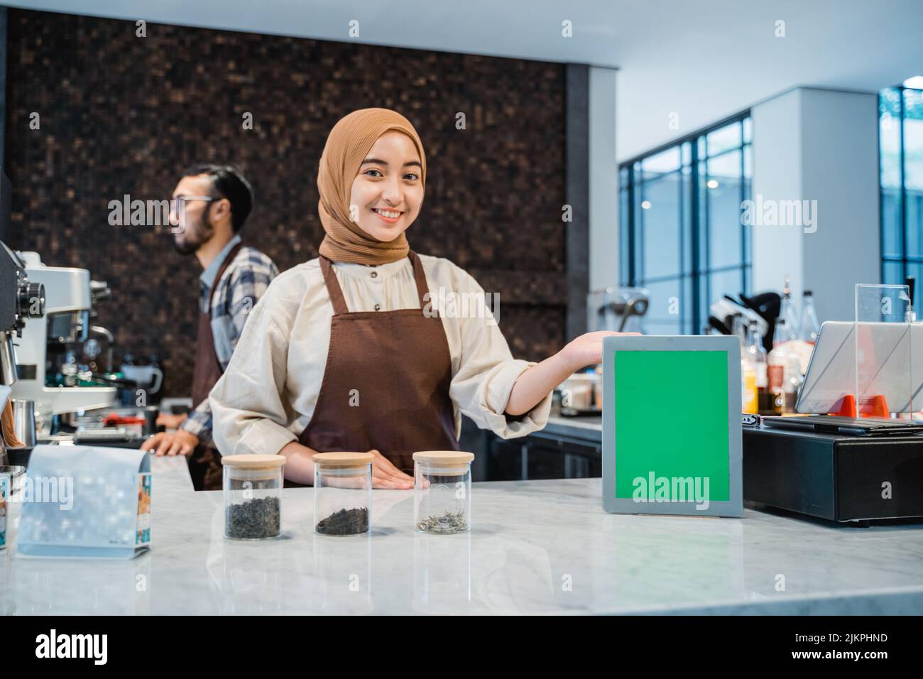 muslim waitress or owner and partner portrait smiling to camera Stock ...