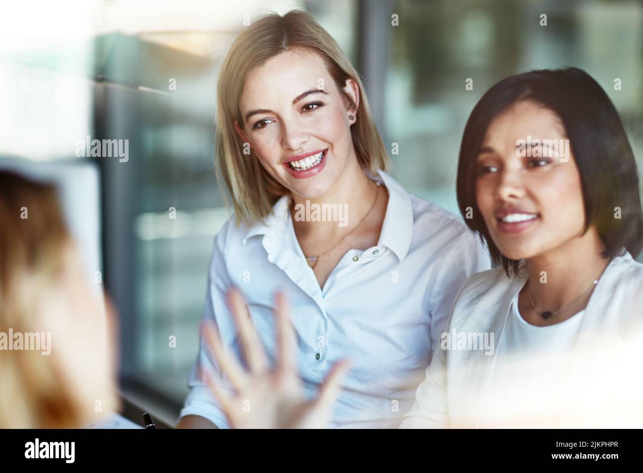 Business people talking, discussing and making conversation in a ...