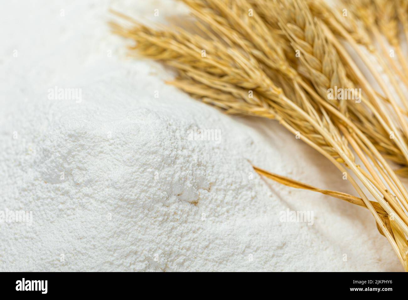 Close-up of a heap of flour and ears of wheat after sifting. Concept ...