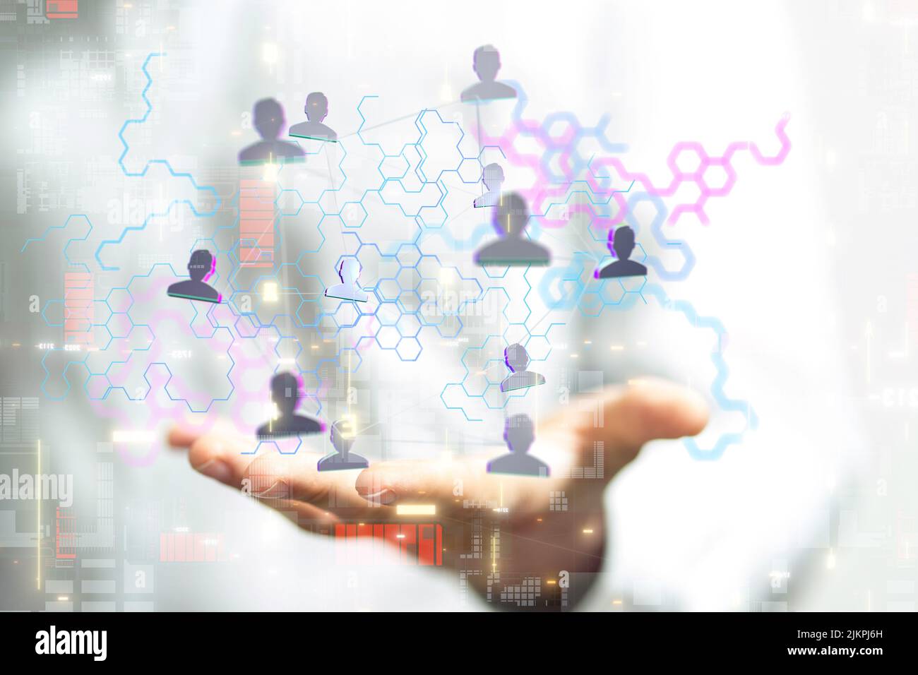 A closeup of a hand holding 3D rendered connected human icons for a ...