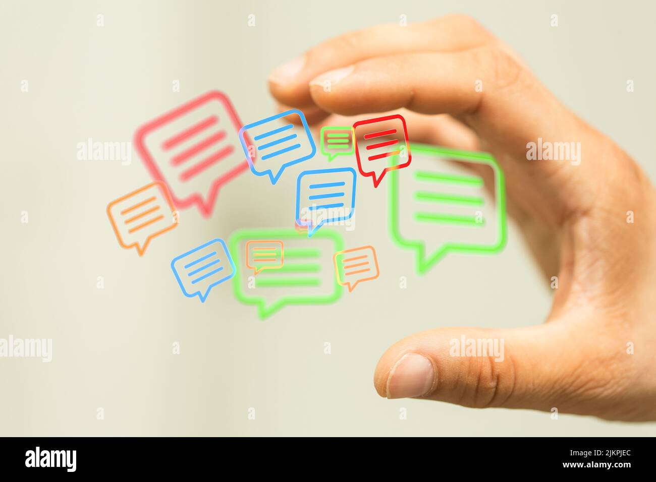 A male hand touching 3D rendering flying Bubble chats icons with his ...