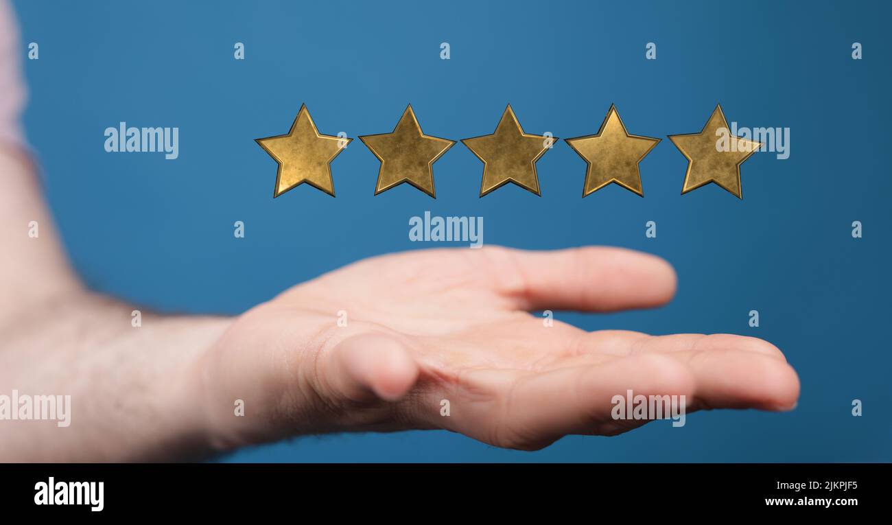 A closeup shot of 3d golden five rating stars on a hand with a blue ...
