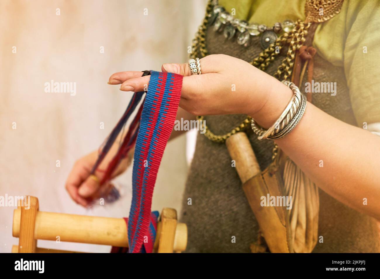 A woman in ancient Byzantine clothing makes yarn and sews from vintage ...