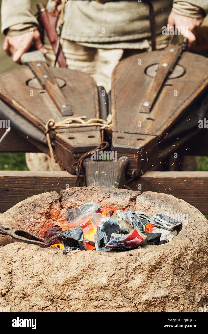 Work of a medieval blacksmith for the manufacture of metal products ...