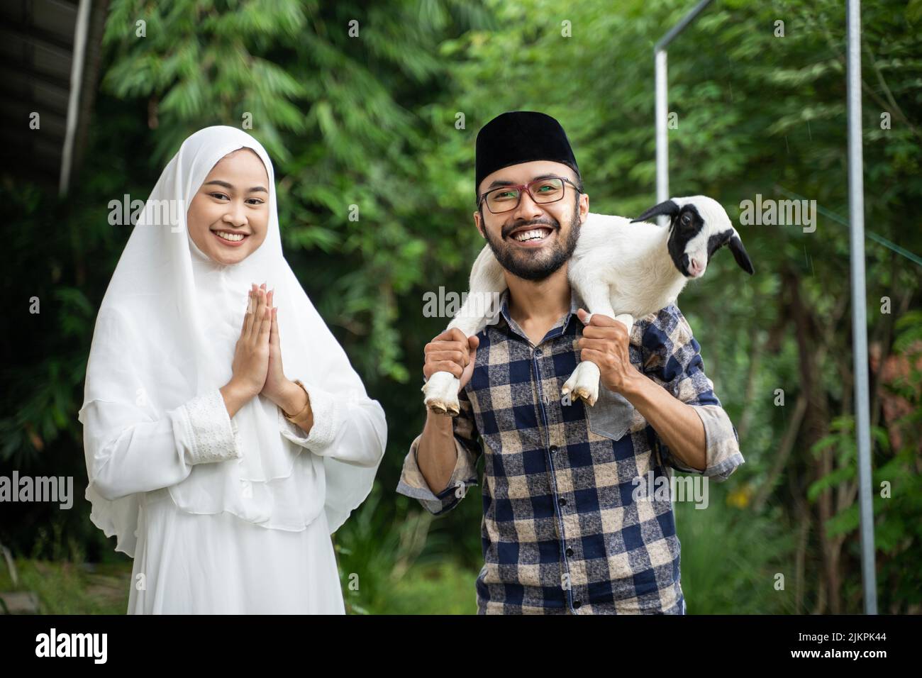 muslim couple buy a goat for eid adha sacrifice or qurban Stock Photo ...