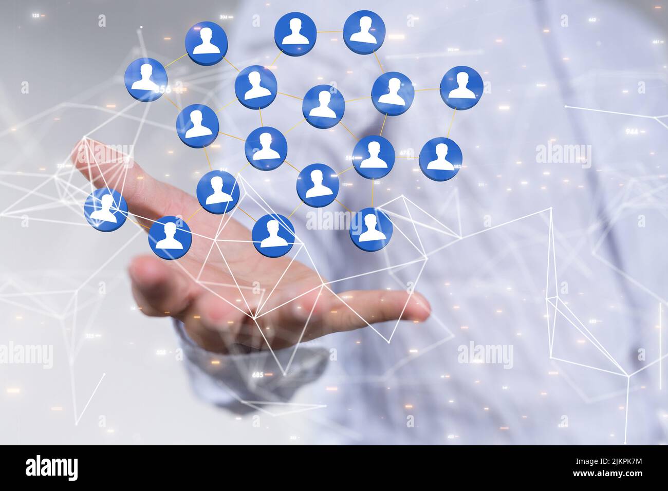 A hand with several blue human profiles above as a digital network ...