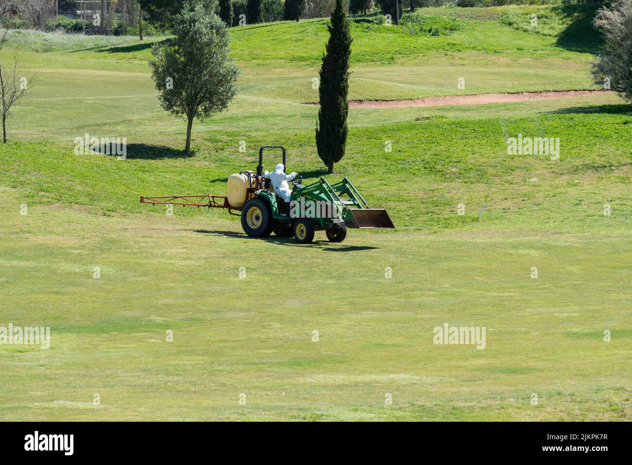A maintenance team with a tractor at the Jamor Golf Course in Lisbon ...