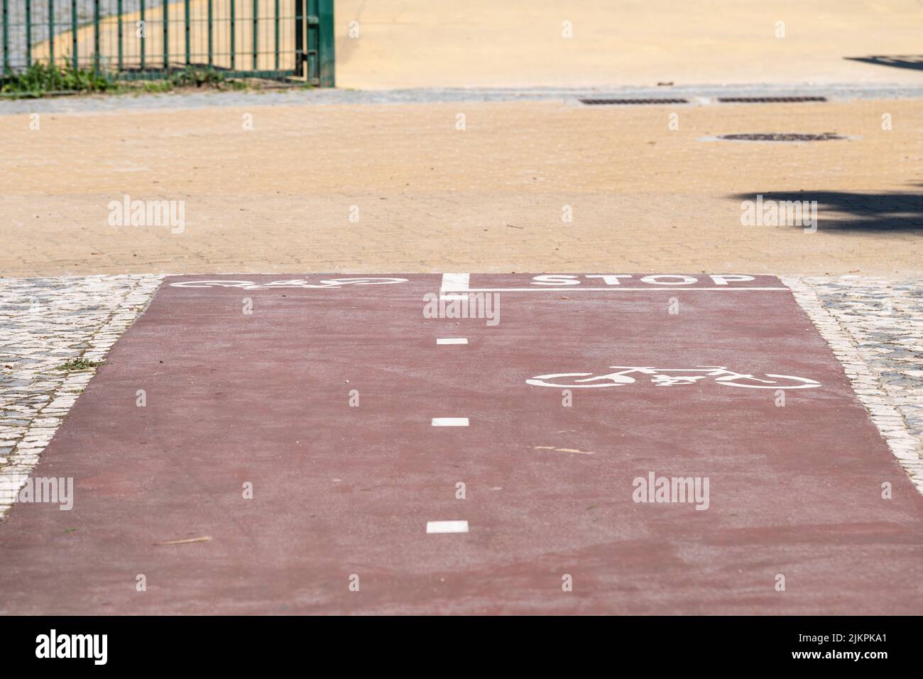 A bike path with a "Stop" text on the ground Stock Photo - Alamy
