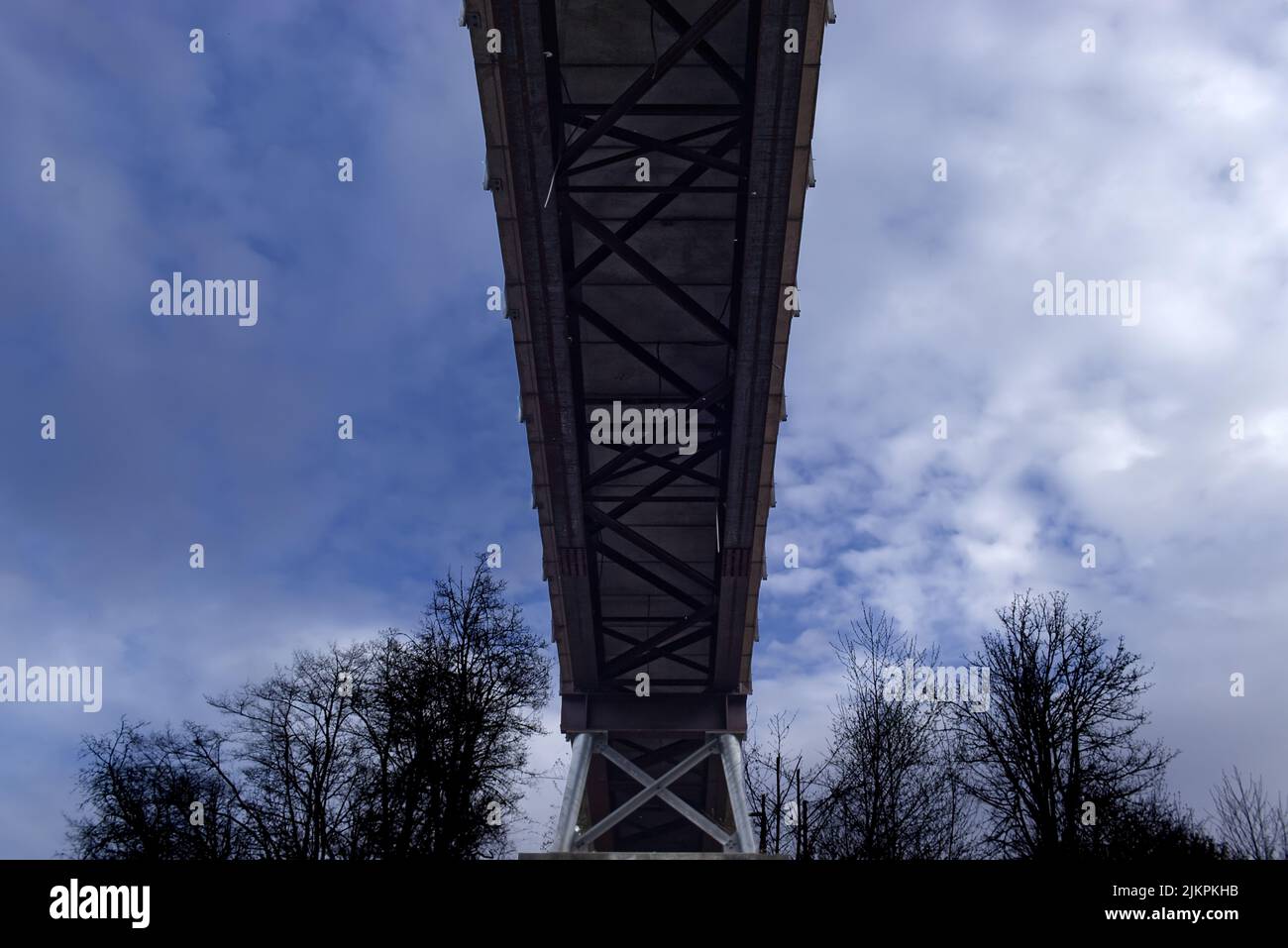 A high stone bridge structure in a rural area in cloudy sky background ...
