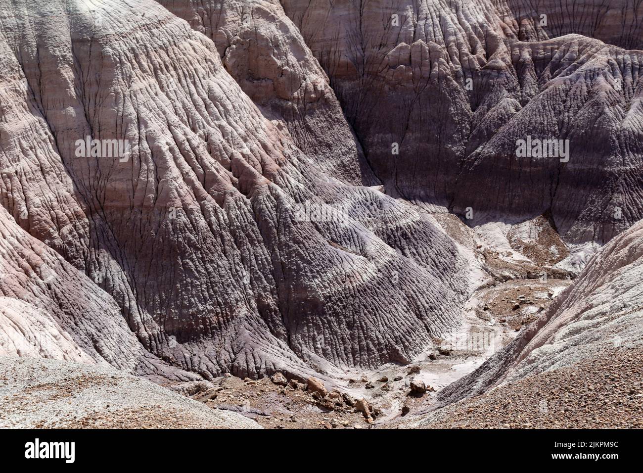 Dry striped rough badlands in a desert under the sunlight Stock Photo ...