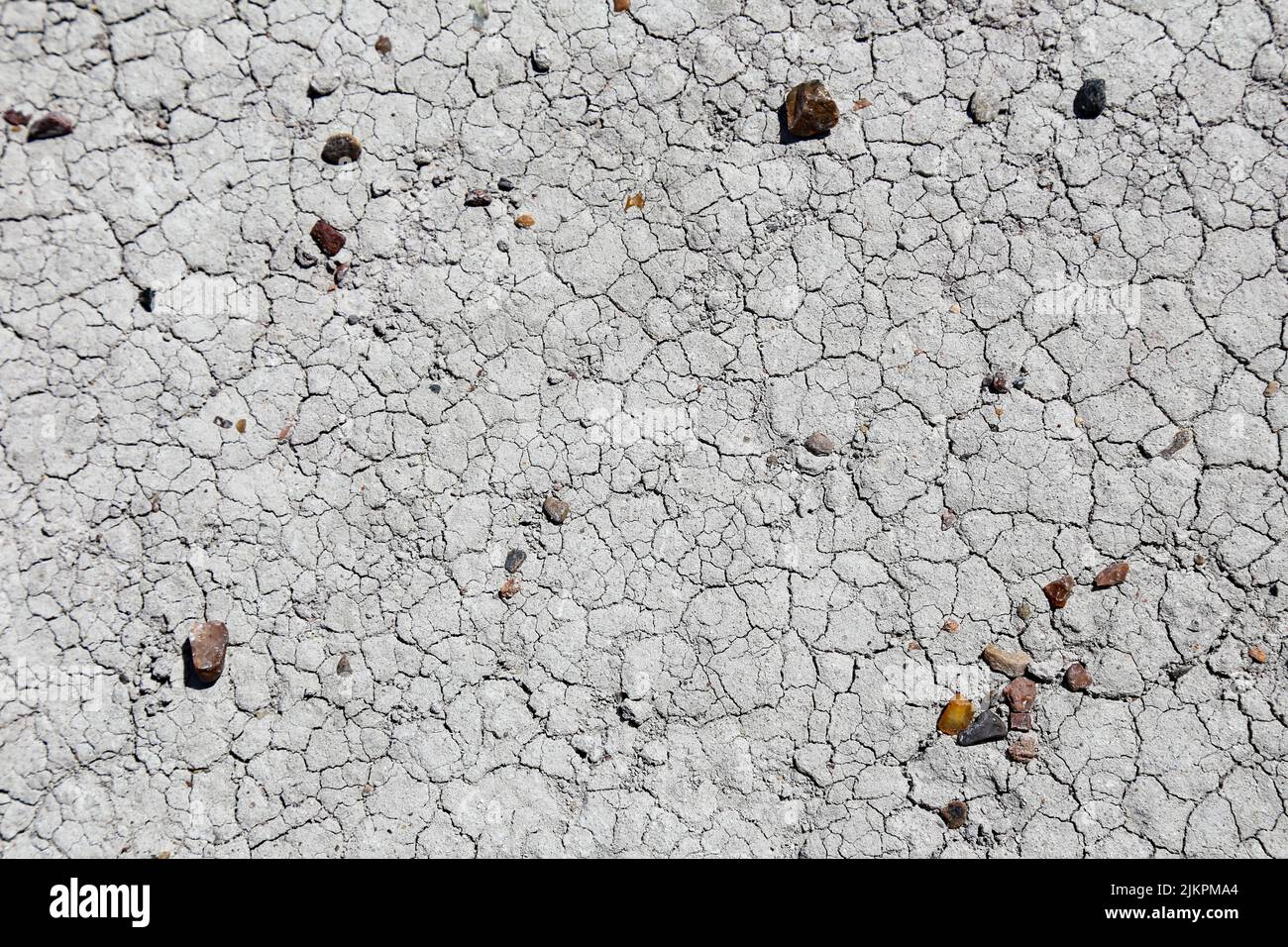 A dry cracked weathered white ground texture Stock Photo - Alamy